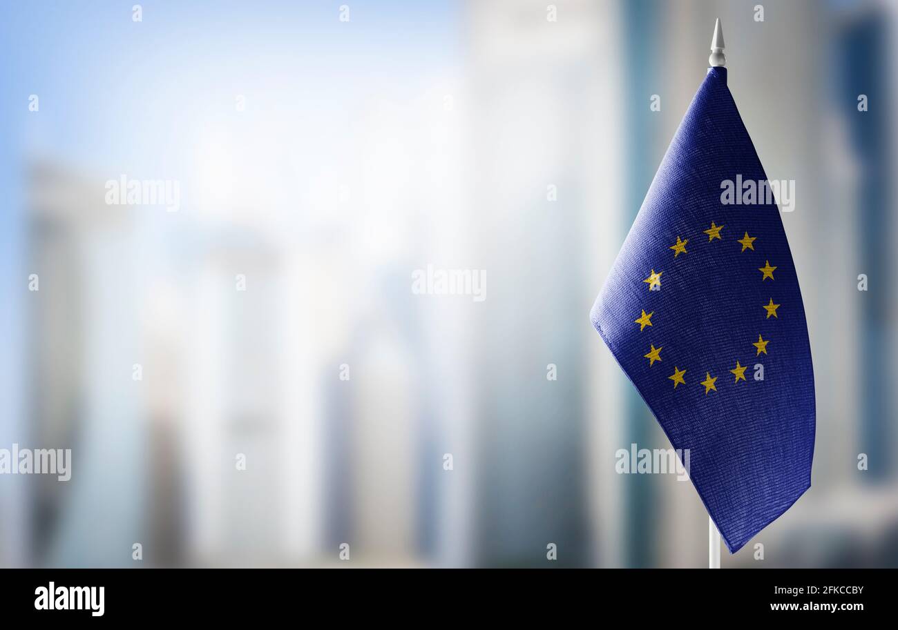 Small national flags of the European Union on a light blurry background ...