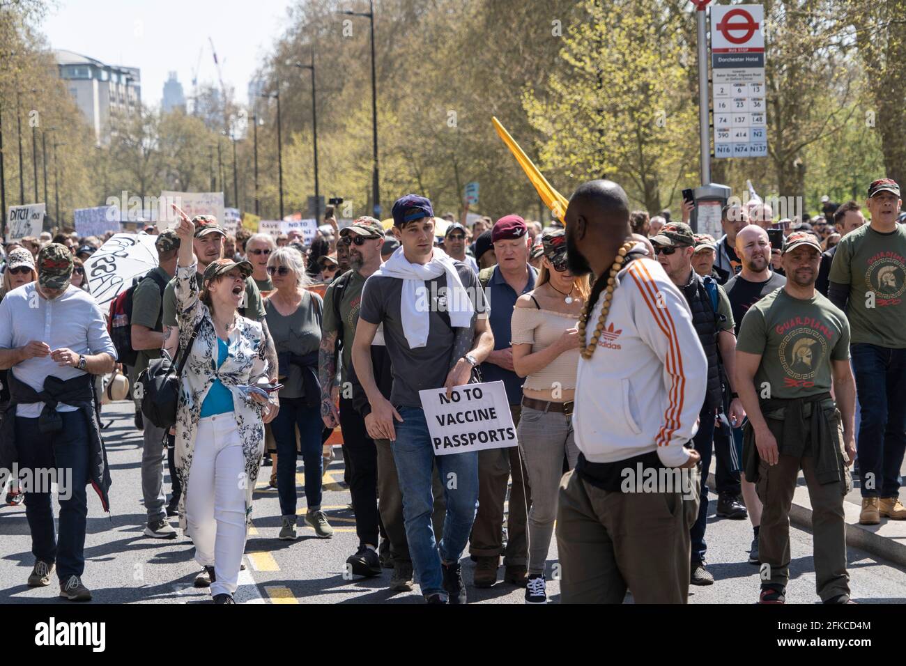 A black man walks infant of thousands protesting vaccine passports in ...
