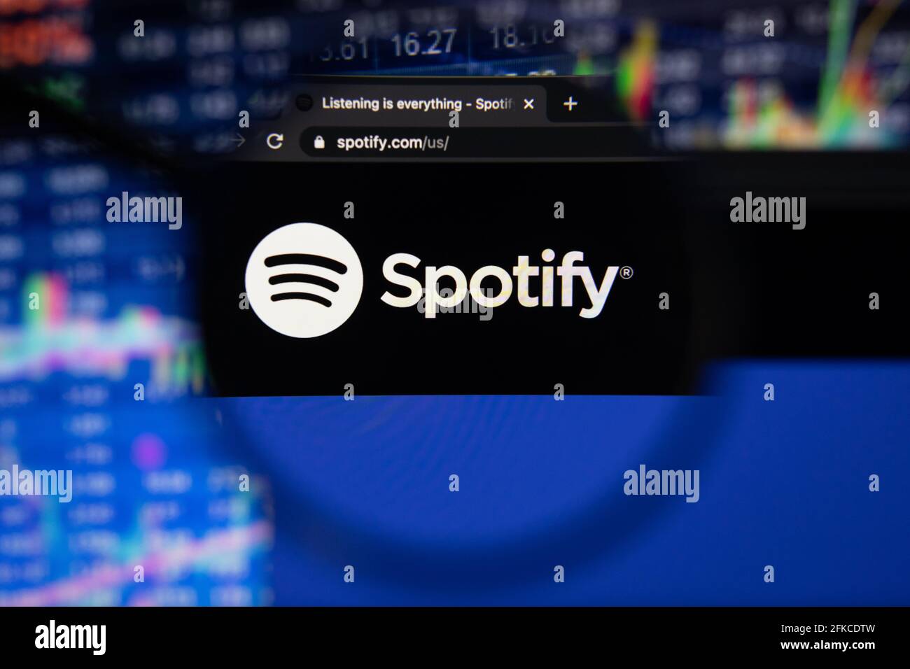 Spotify company logo on a website with blurry stock market developments ...