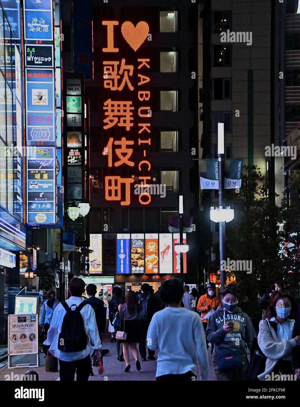 Tokyo, Japan. 30th Apr, 2021. Pedestrians wearing face masks walk at ...