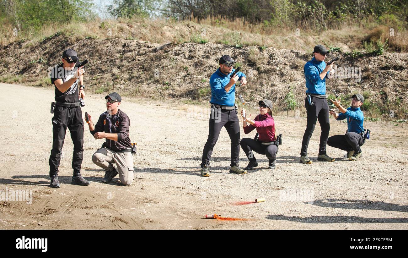 Group of students on training for handling and shooting in shooting ...