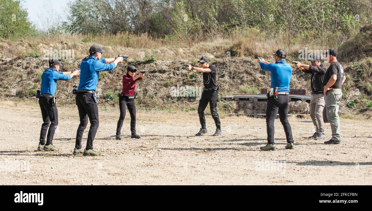 Group of students on training for handling and shooting in shooting ...