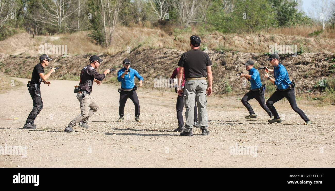Group of students on training for handling and shooting in shooting ...