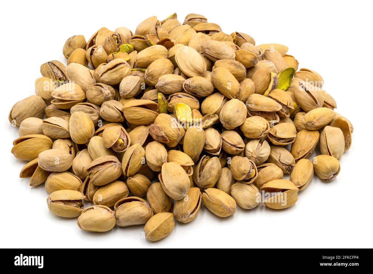 A set of salted and roasted pistachio seeds on a white background ...