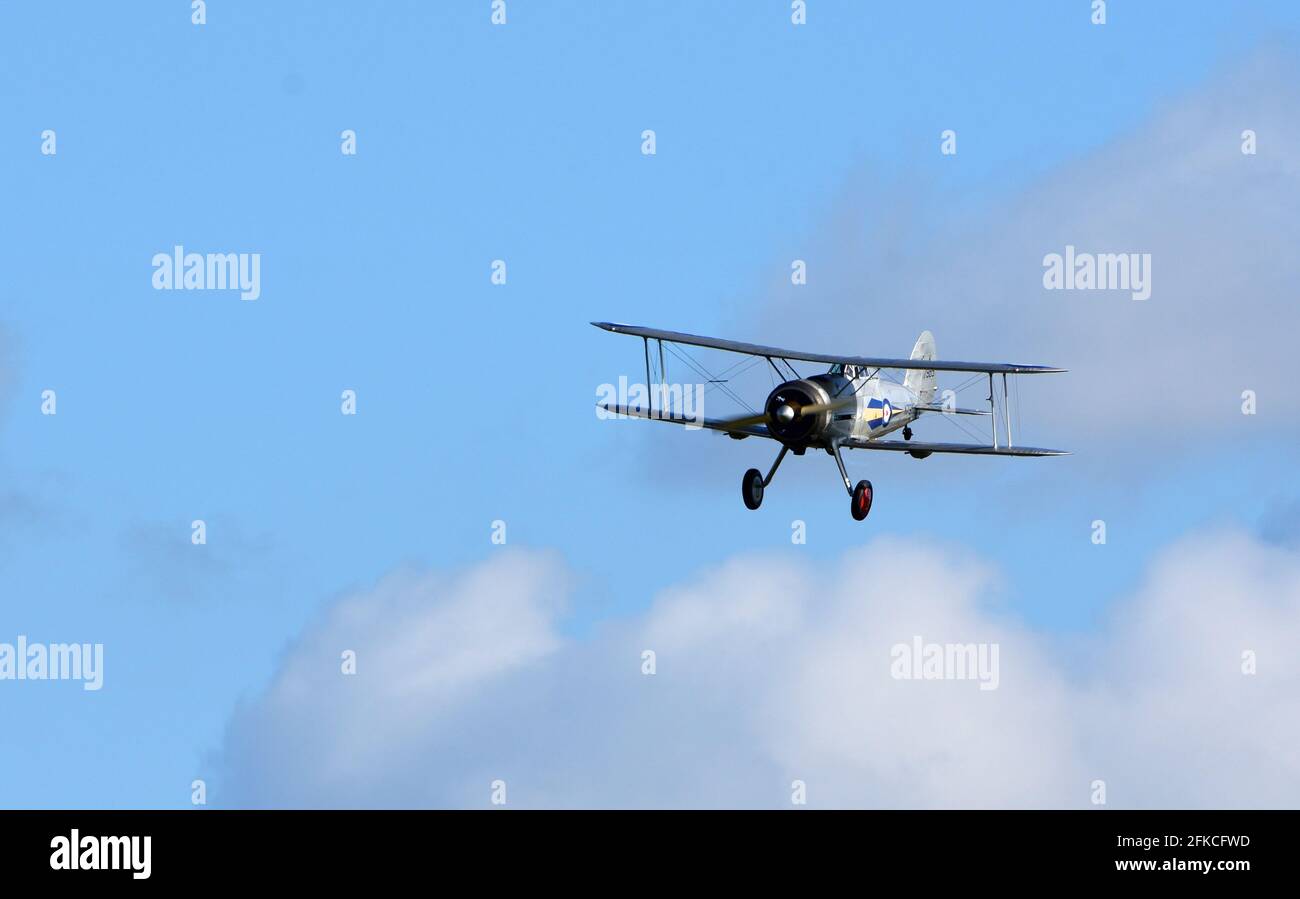 Gloster Gladiator aircraft in flight with cloud and blue sky background ...