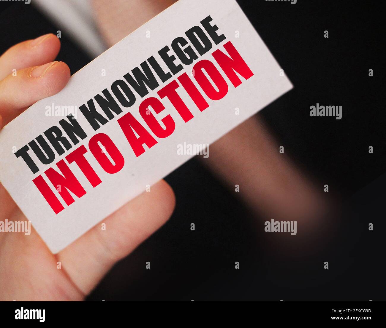 Turn Knowledge Into Action card in businessman hand. Business concept ...