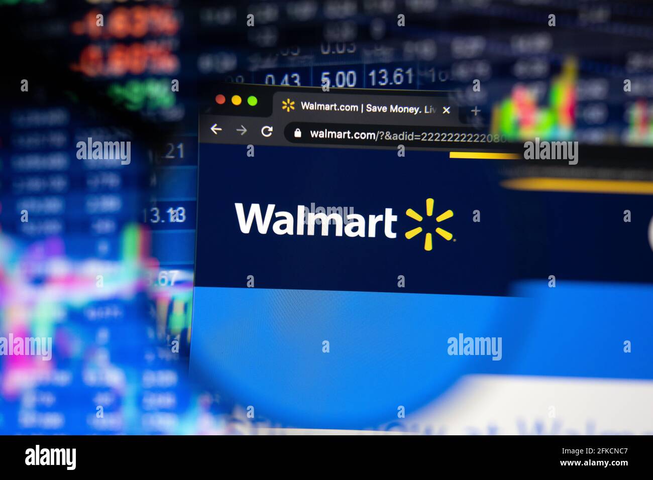 Walmart company logo on a website with blurry stock market developments in the background, seen ...