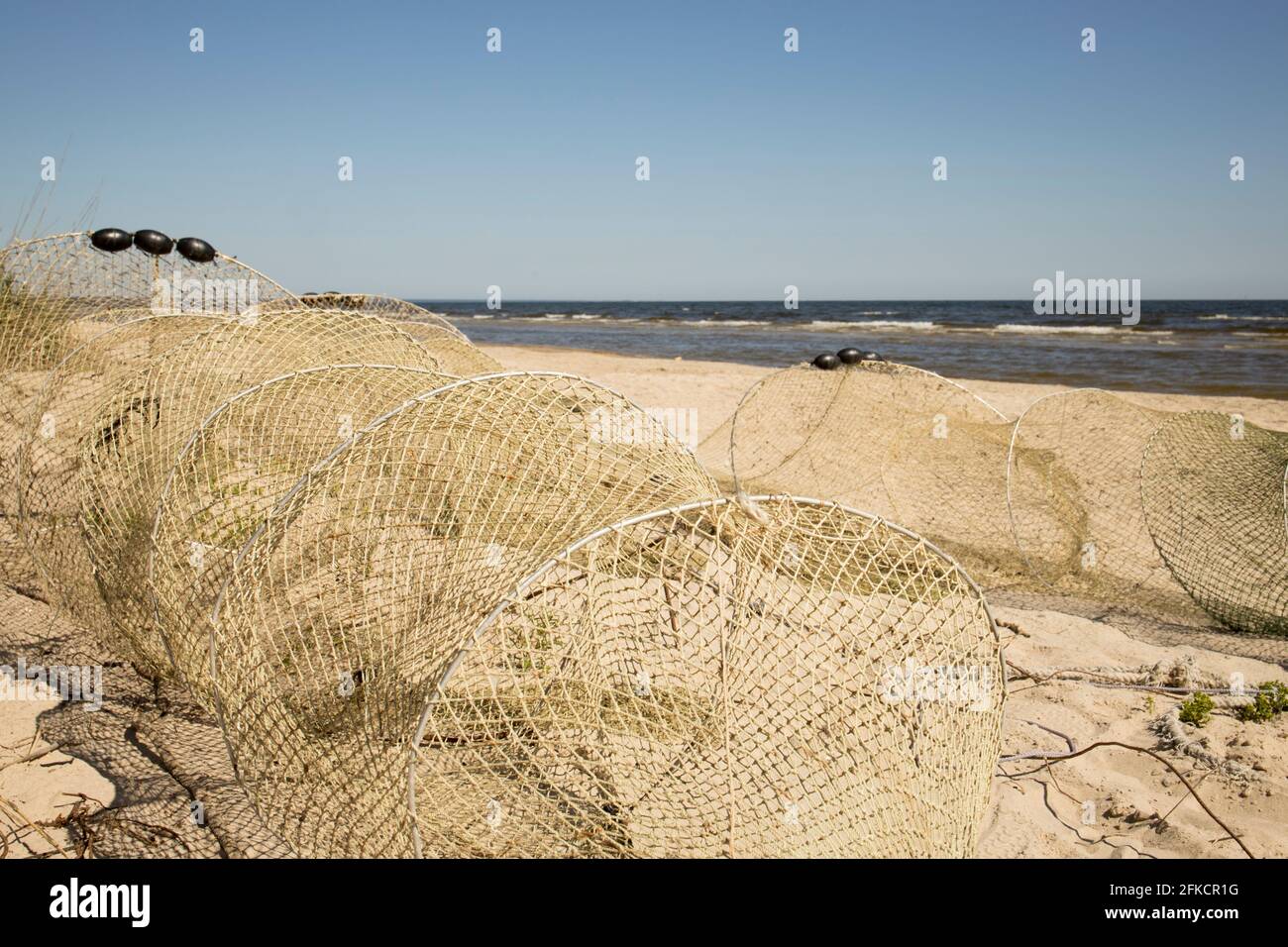 Fishing net spread out on a sandy beach Stock Photo - Alamy