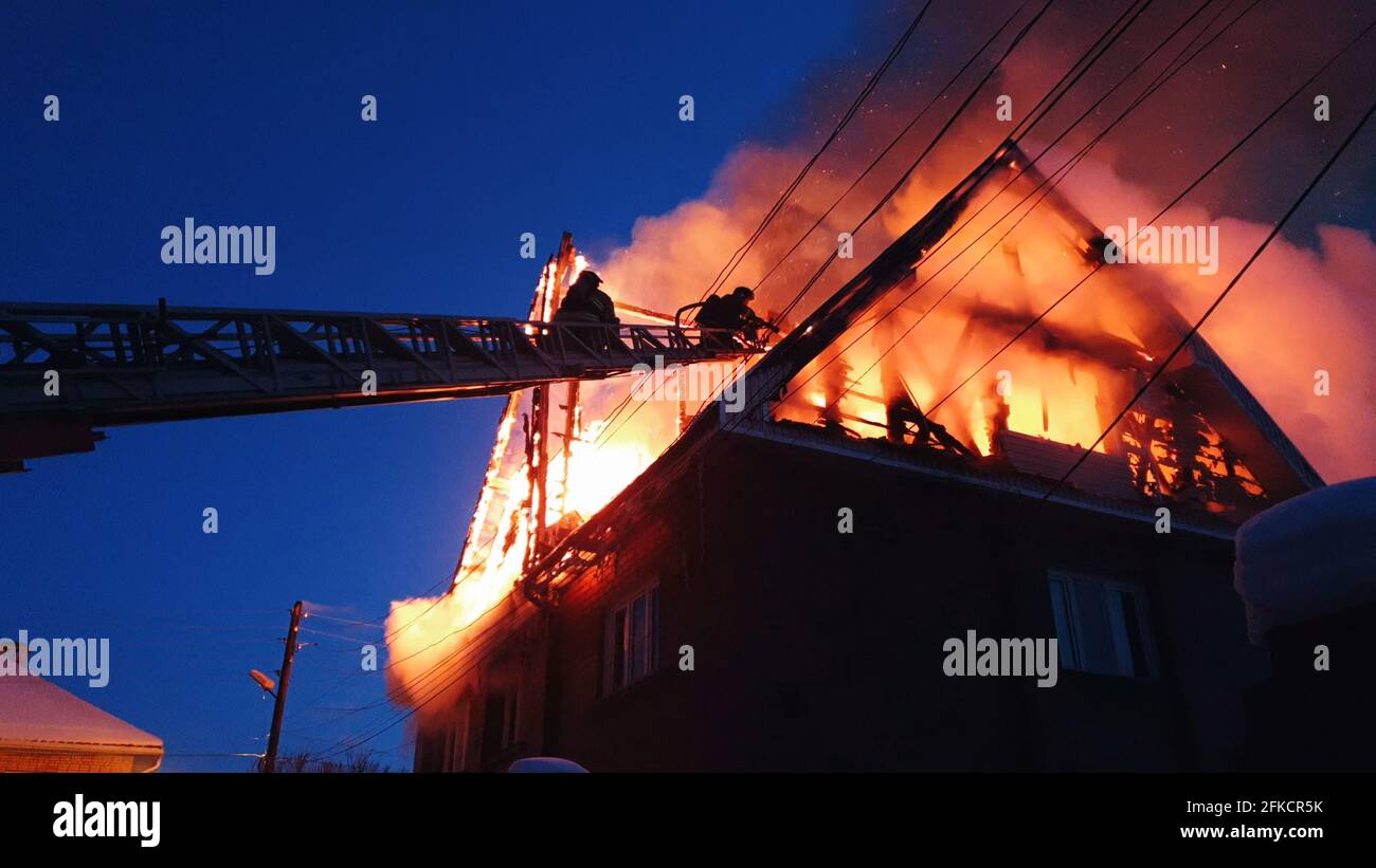 The roof of the house is on fire. The residential building burn ...