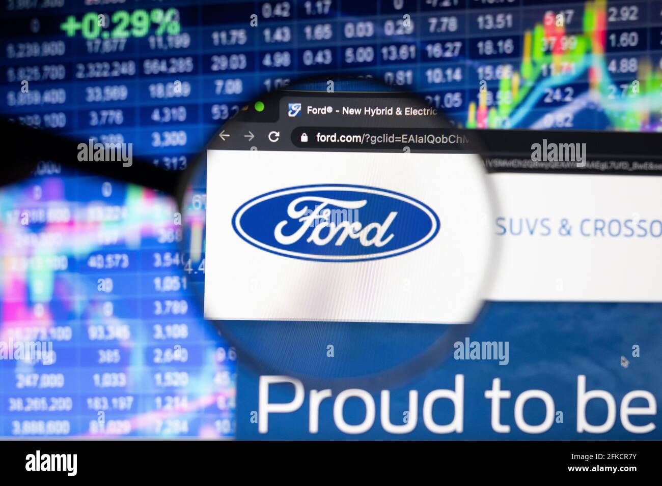 Ford company logo on a website with blurry stock market developments in the background, seen on ...