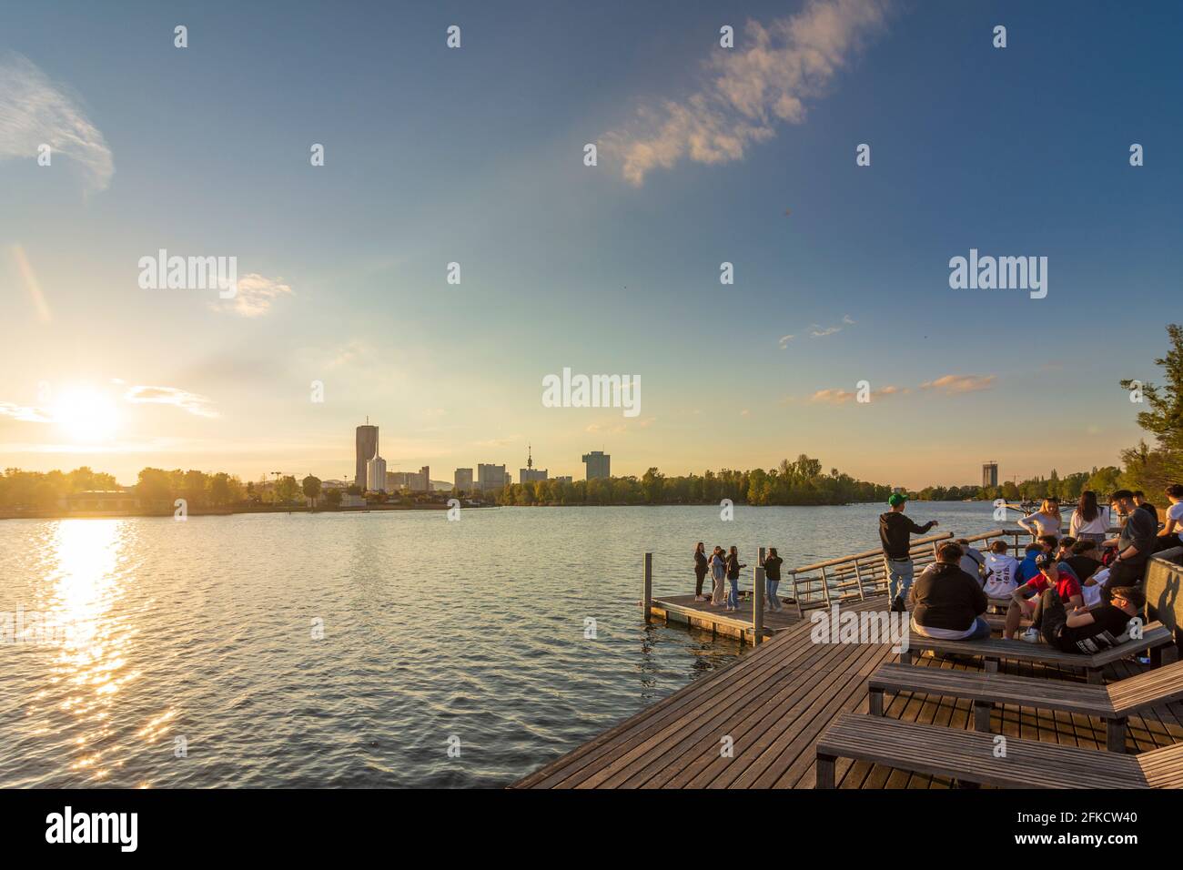 Wien, Vienna: oxbow lake Alte Donau (Old Danube), young people sitting ...