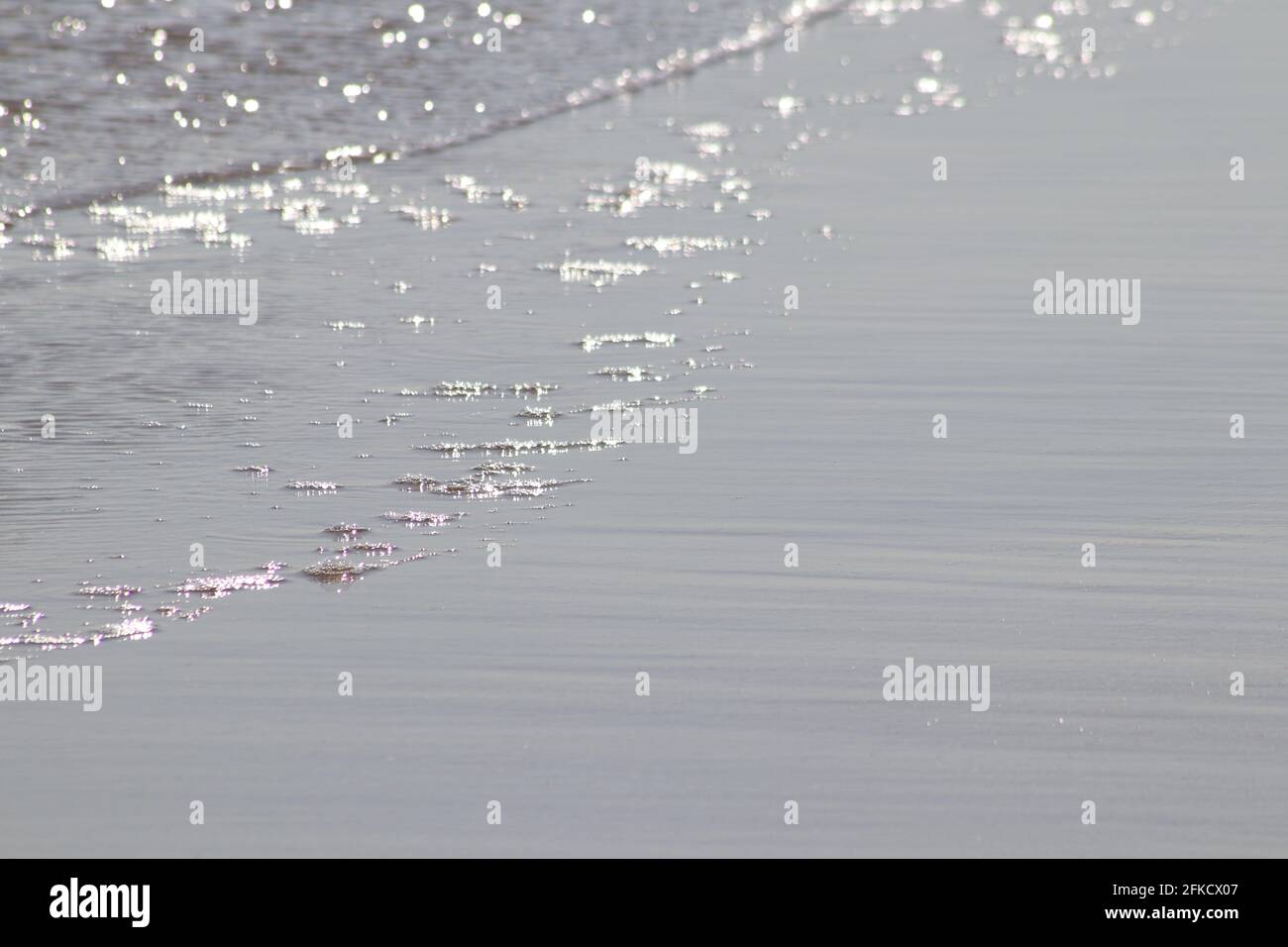 Blue bubbles on beach Stock Photo - Alamy