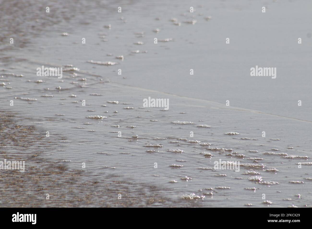 Blue bubbles on beach Stock Photo - Alamy