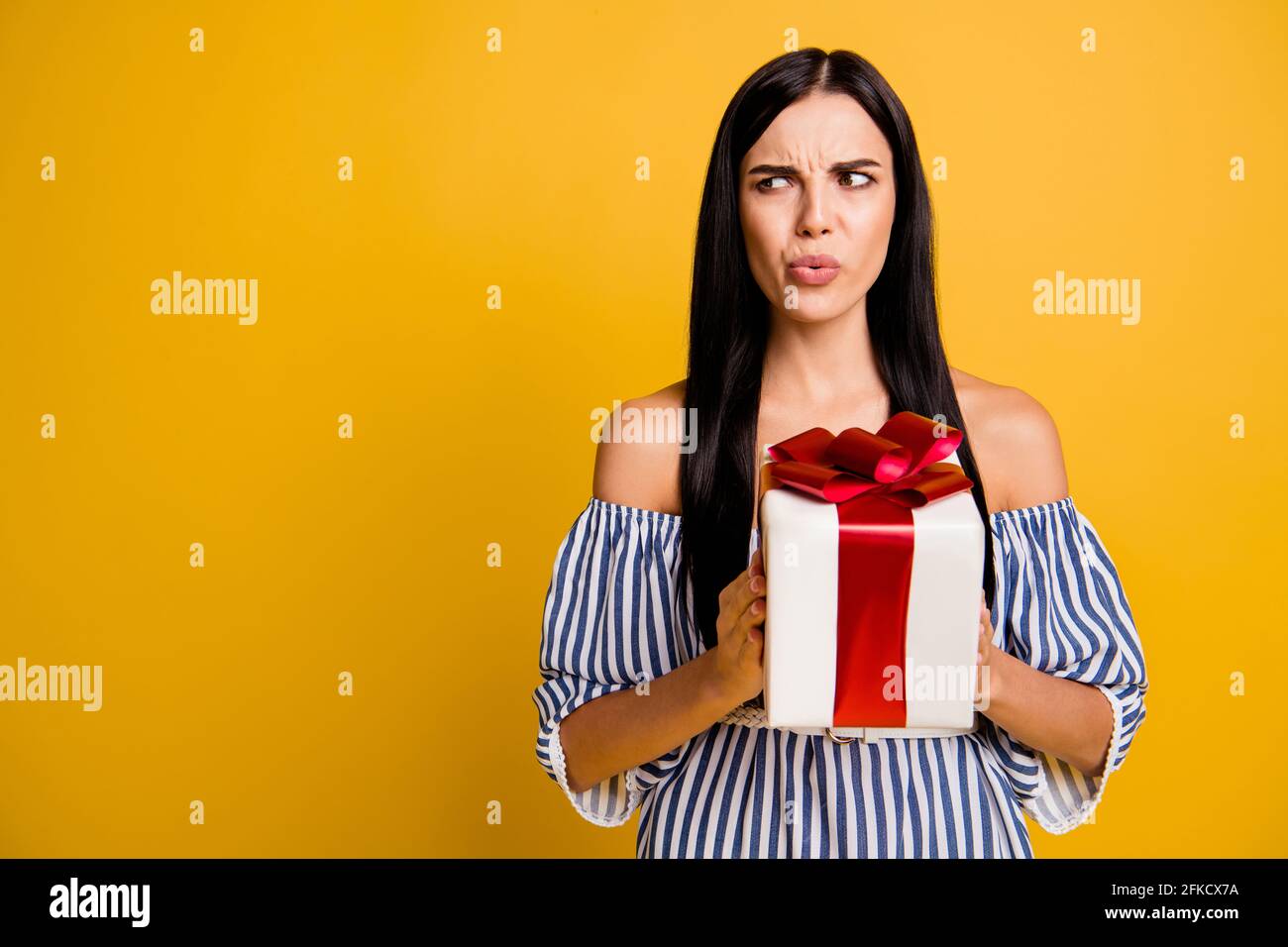 Photo of upset young woman dressed off-shoulders dress dislike present ...