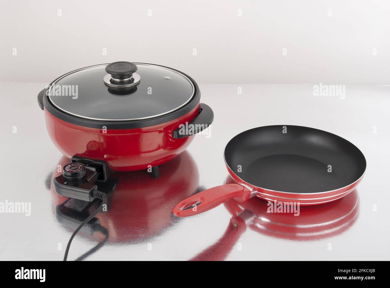 Antiaderente red electric skillet and pan Stock Photo - Alamy