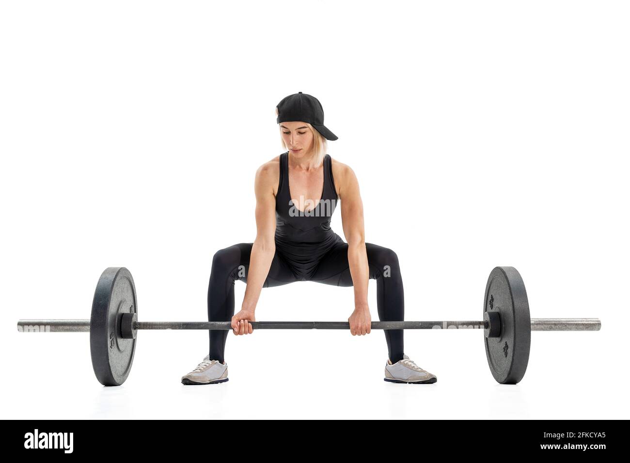 Young woman doing deadlift with a barbell isolated on white Stock Photo ...
