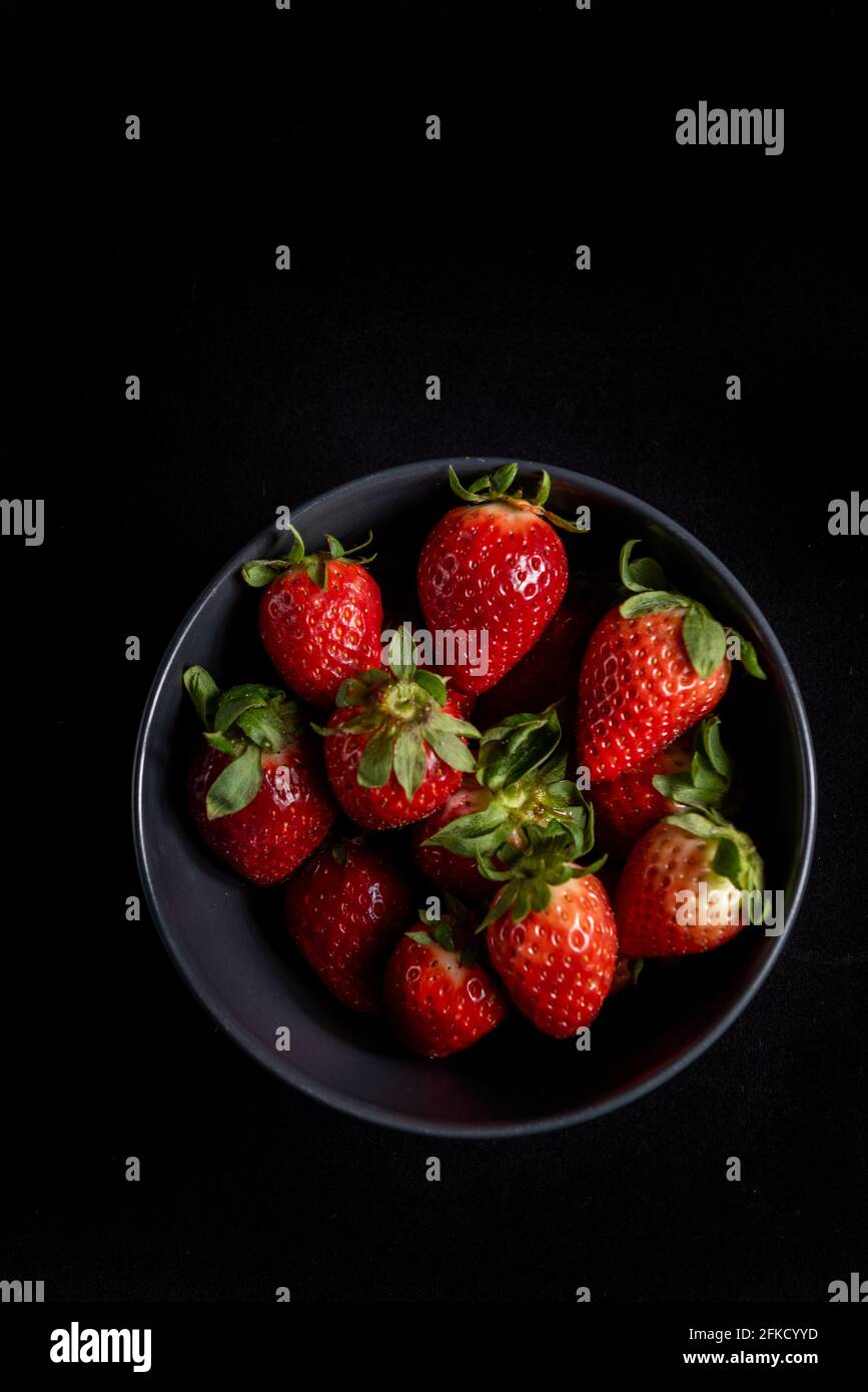 Strawberries in background black Stock Photo - Alamy