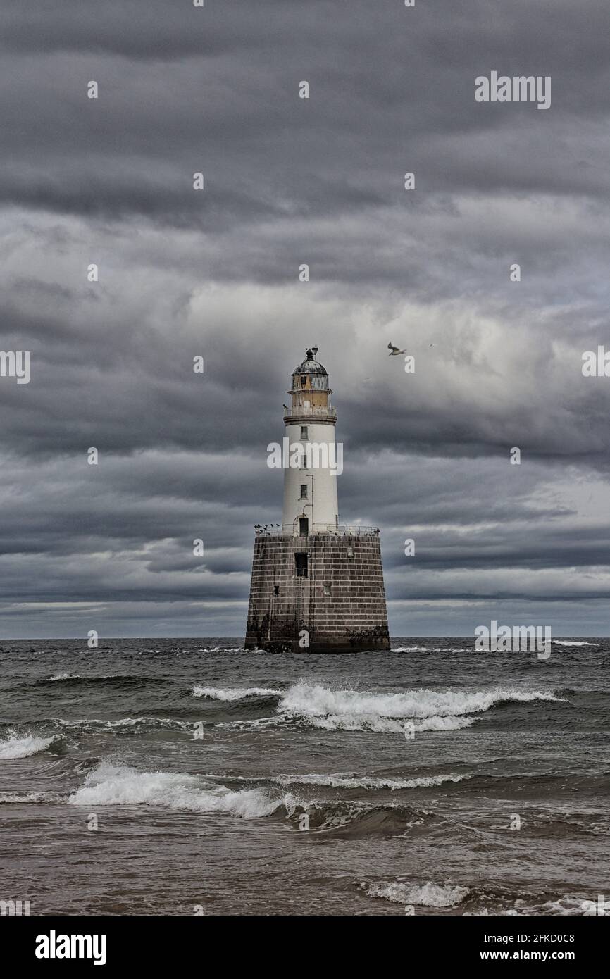White lighthouse on pedestal in sea Stock Photo - Alamy