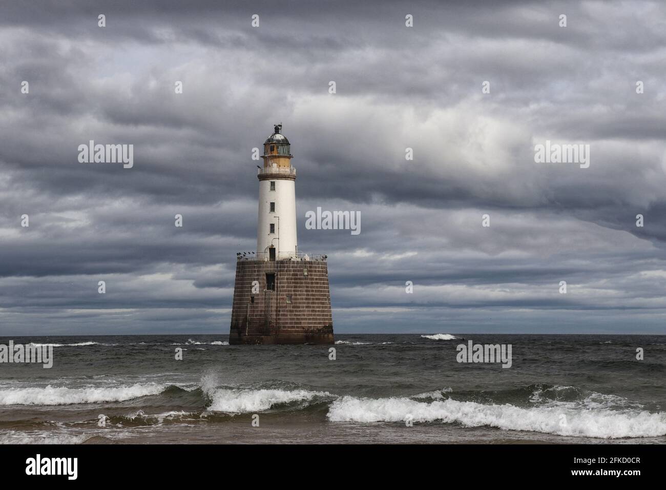 White lighthouse on pedestal in sea Stock Photo - Alamy