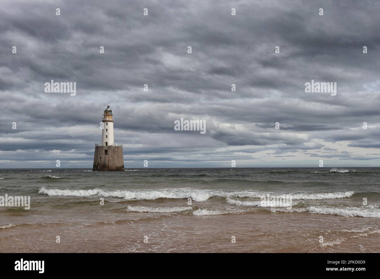 White lighthouse on pedestal in sea Stock Photo - Alamy