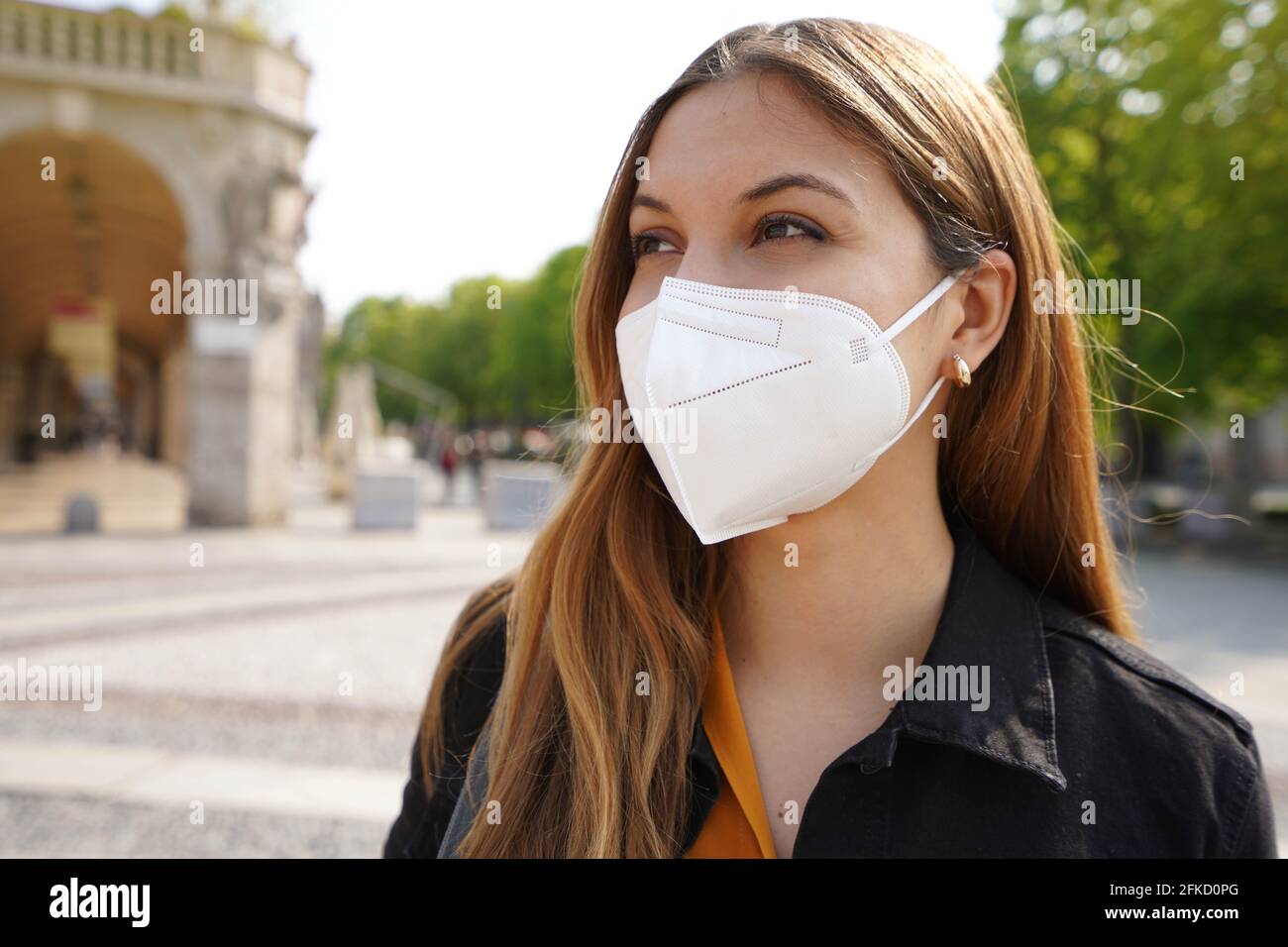 Close up portrait of young woman looking to the side while wearing ...