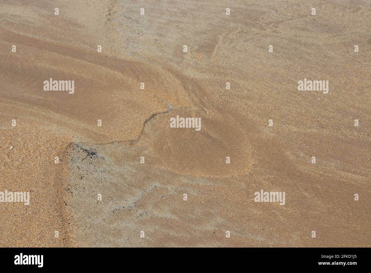 Patterns and textures in sand and seawater Stock Photo - Alamy