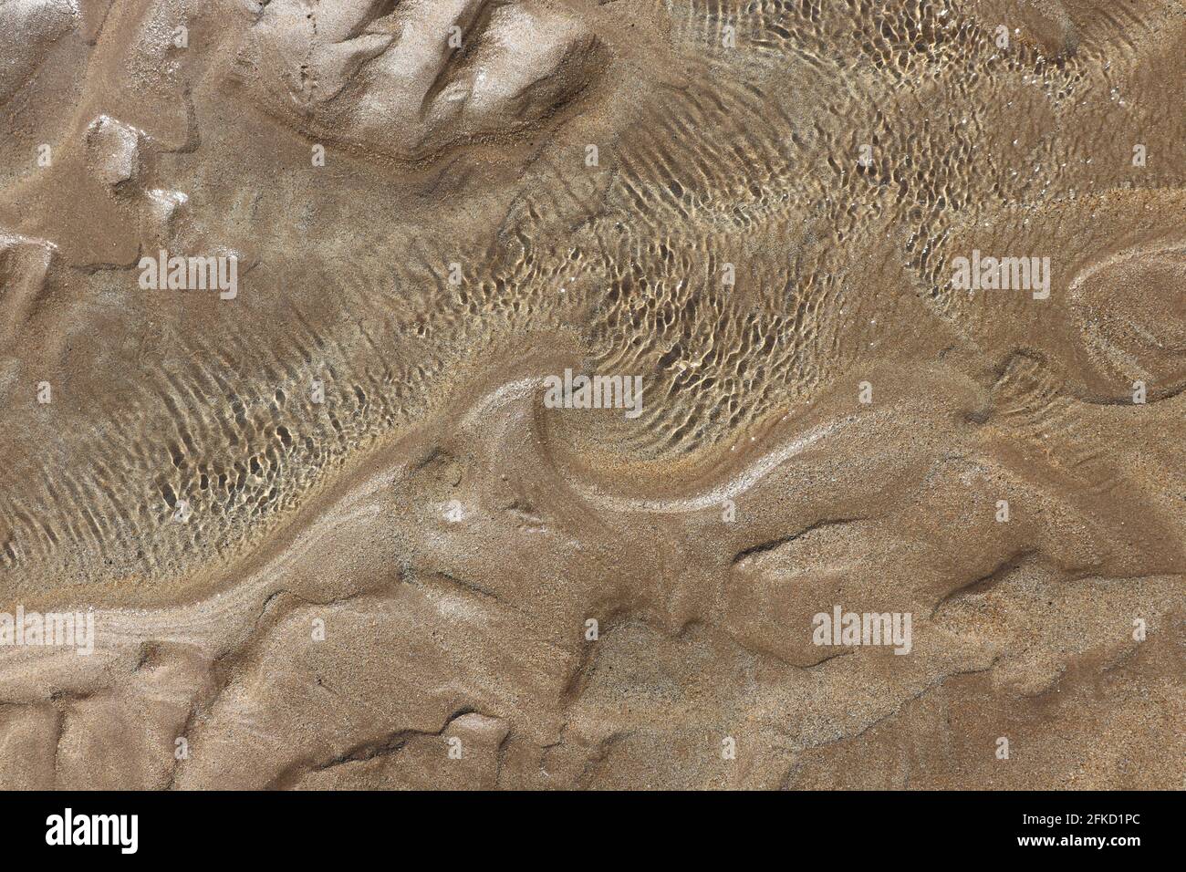 Patterns and textures in sand and seawater Stock Photo - Alamy