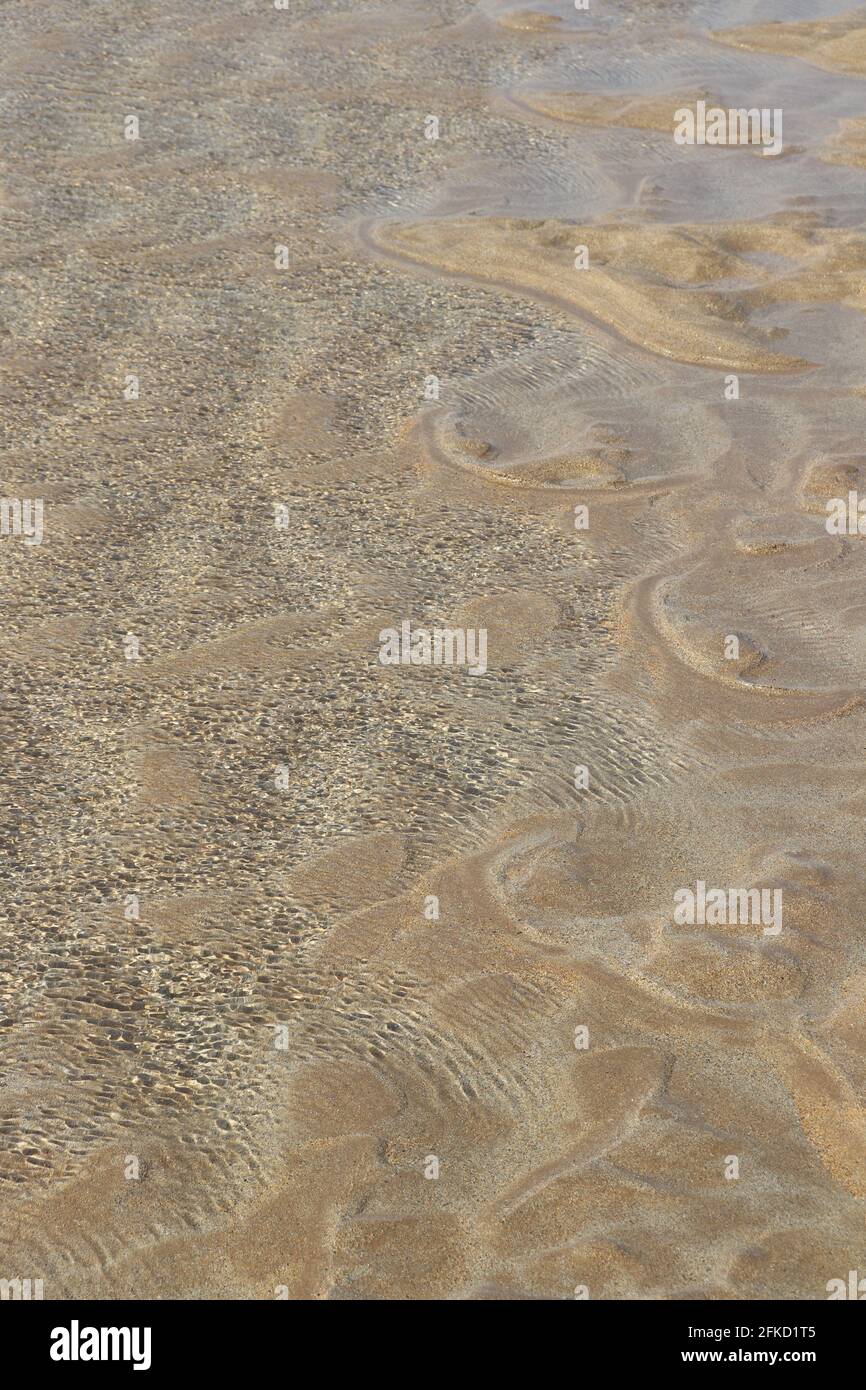 Patterns and textures in sand and seawater Stock Photo - Alamy