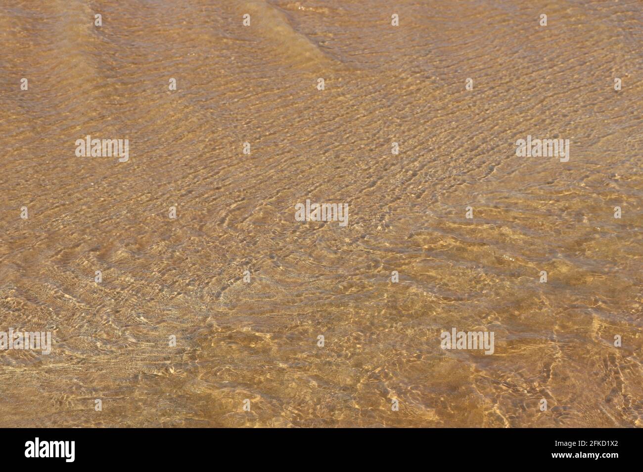 Patterns and textures in sand and seawater Stock Photo - Alamy