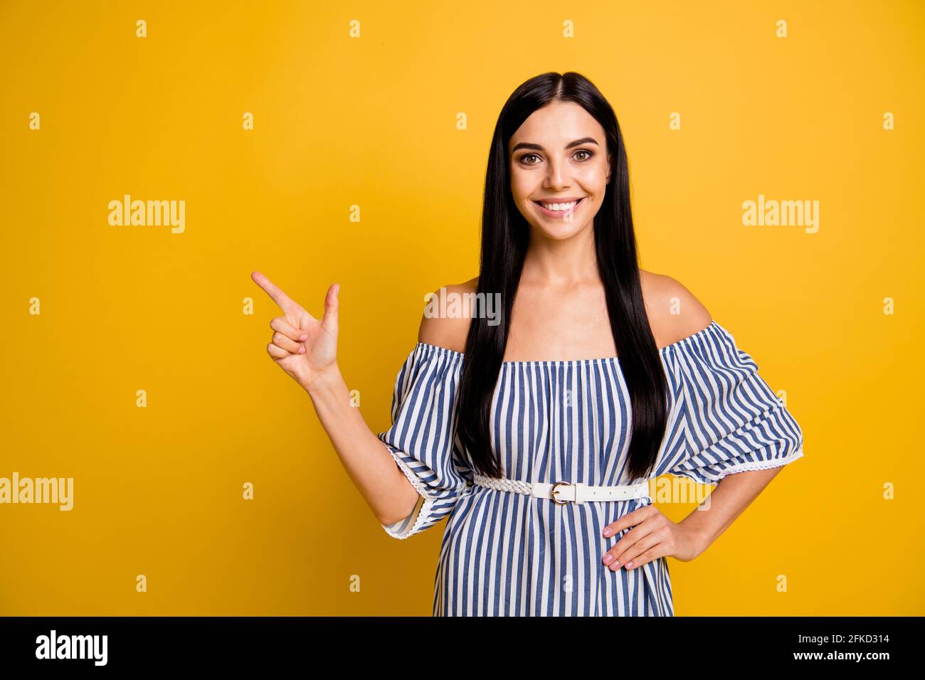 Photo of cute adorable young lady wear striped dress pointing one ...