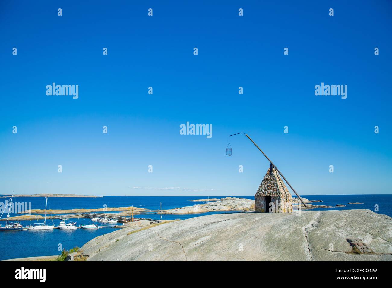 Replica of an old lighthouse. Serene Scandinavian summer landscape on ...