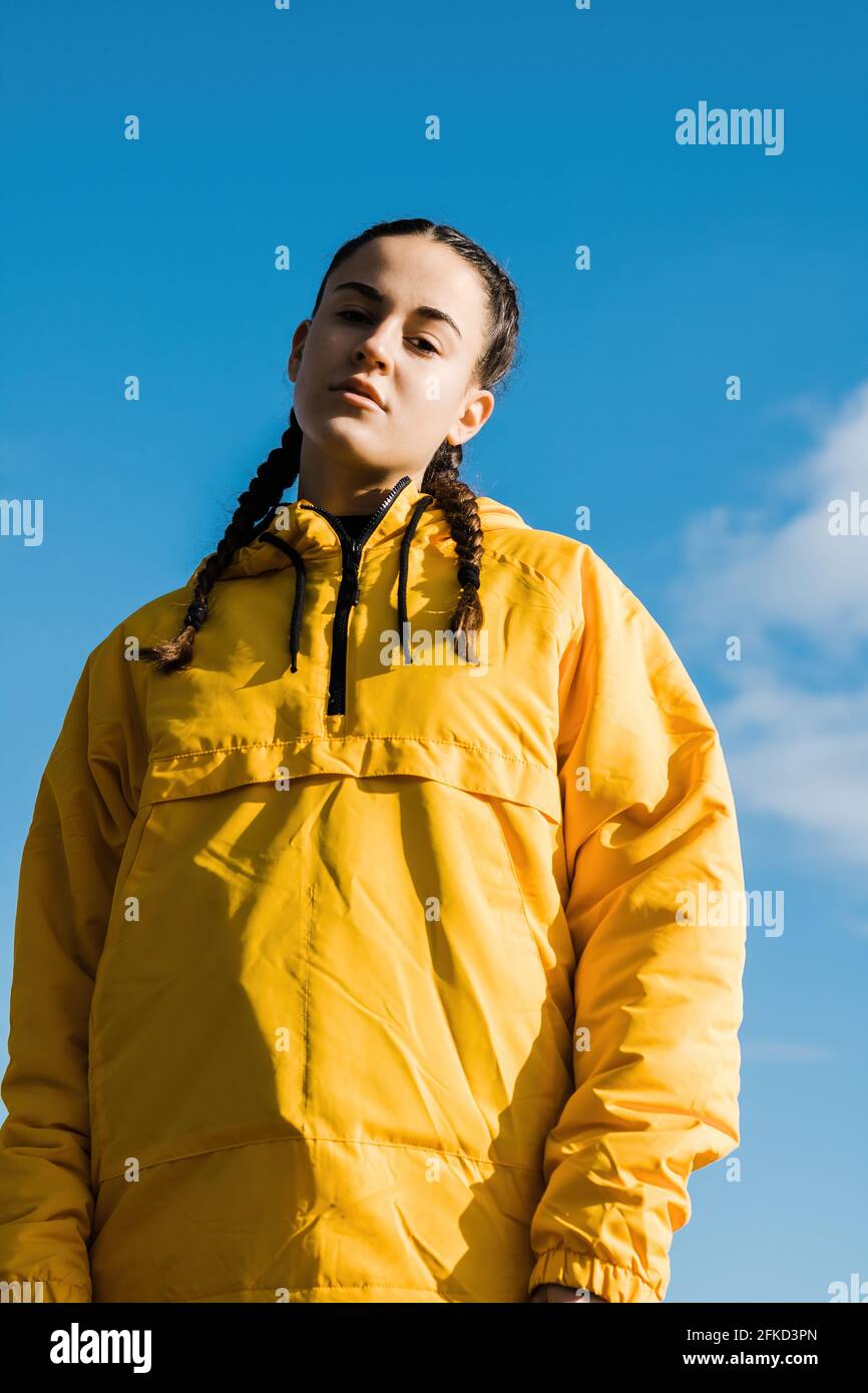 Portrait of teenage girl in yellow coat Stock Photo - Alamy