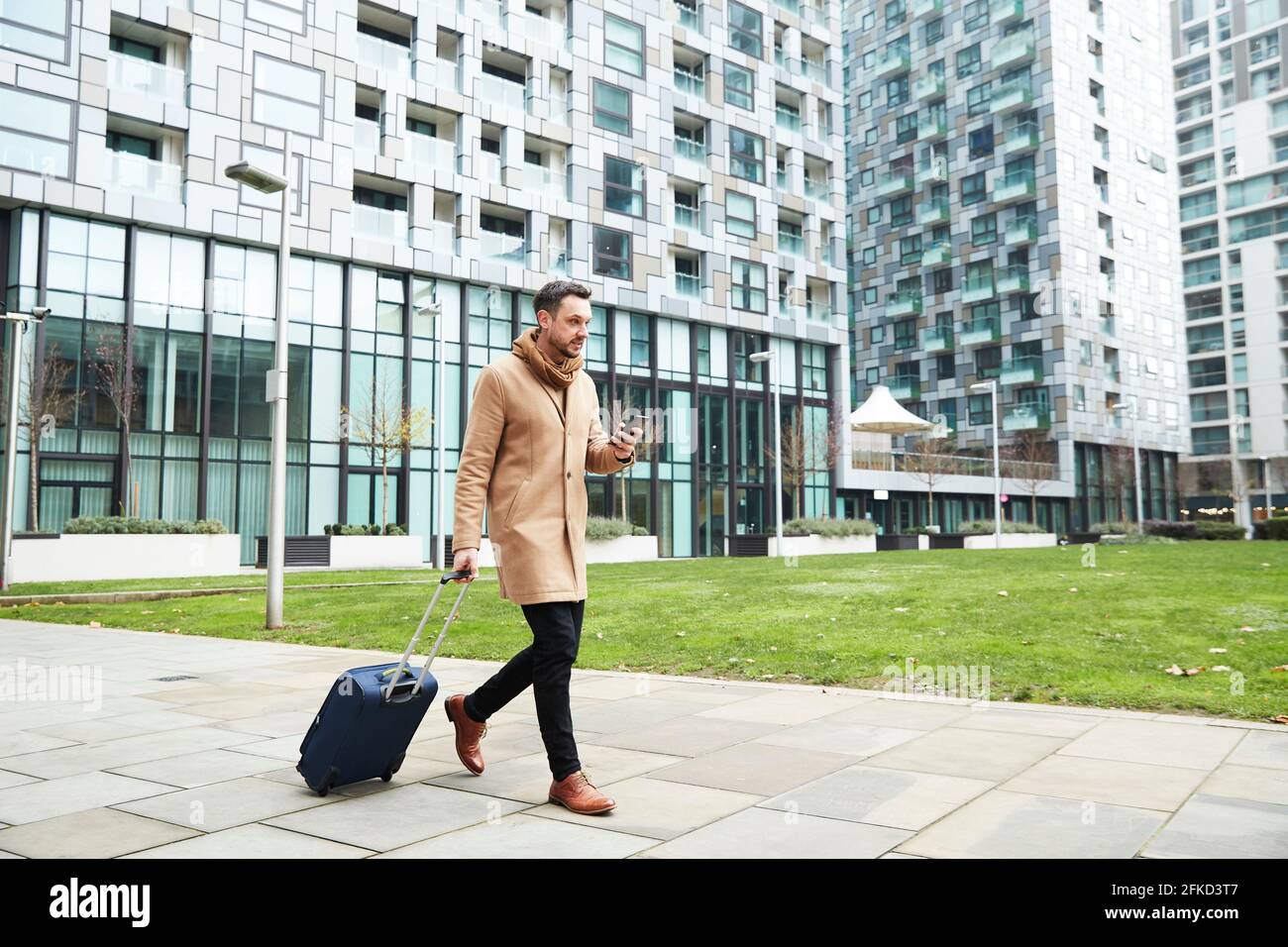 Man pulling suitcase hi-res stock photography and images - Alamy