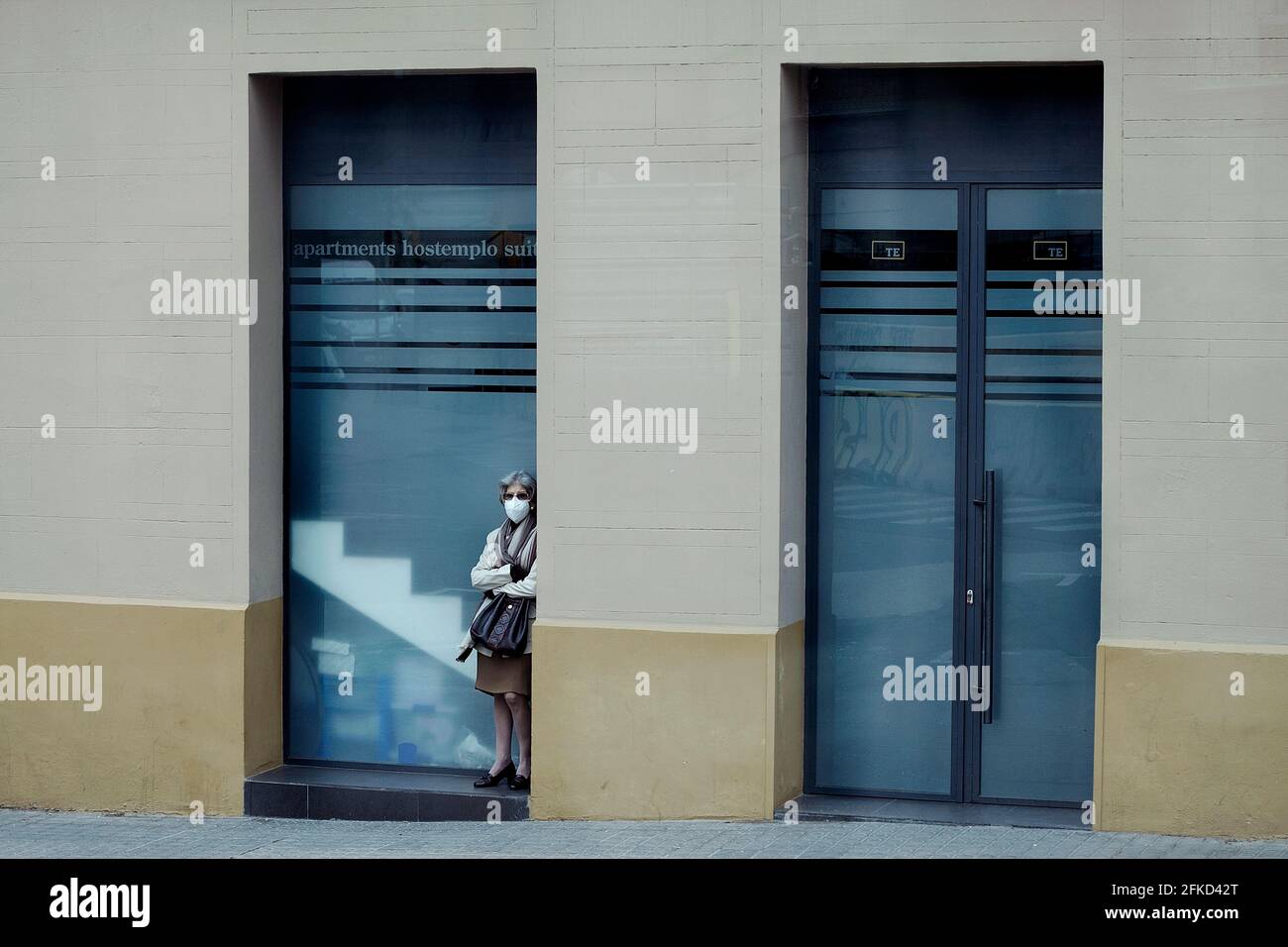 Woman standing in recess of building, Barcelona, Spain Stock Photo - Alamy