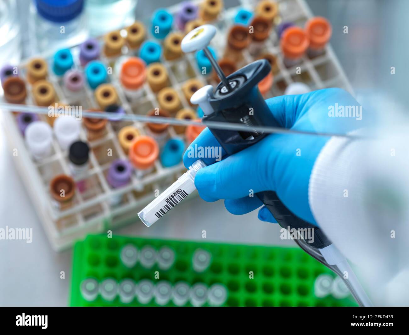 Person holding pipette with test tube hi-res stock photography and ...
