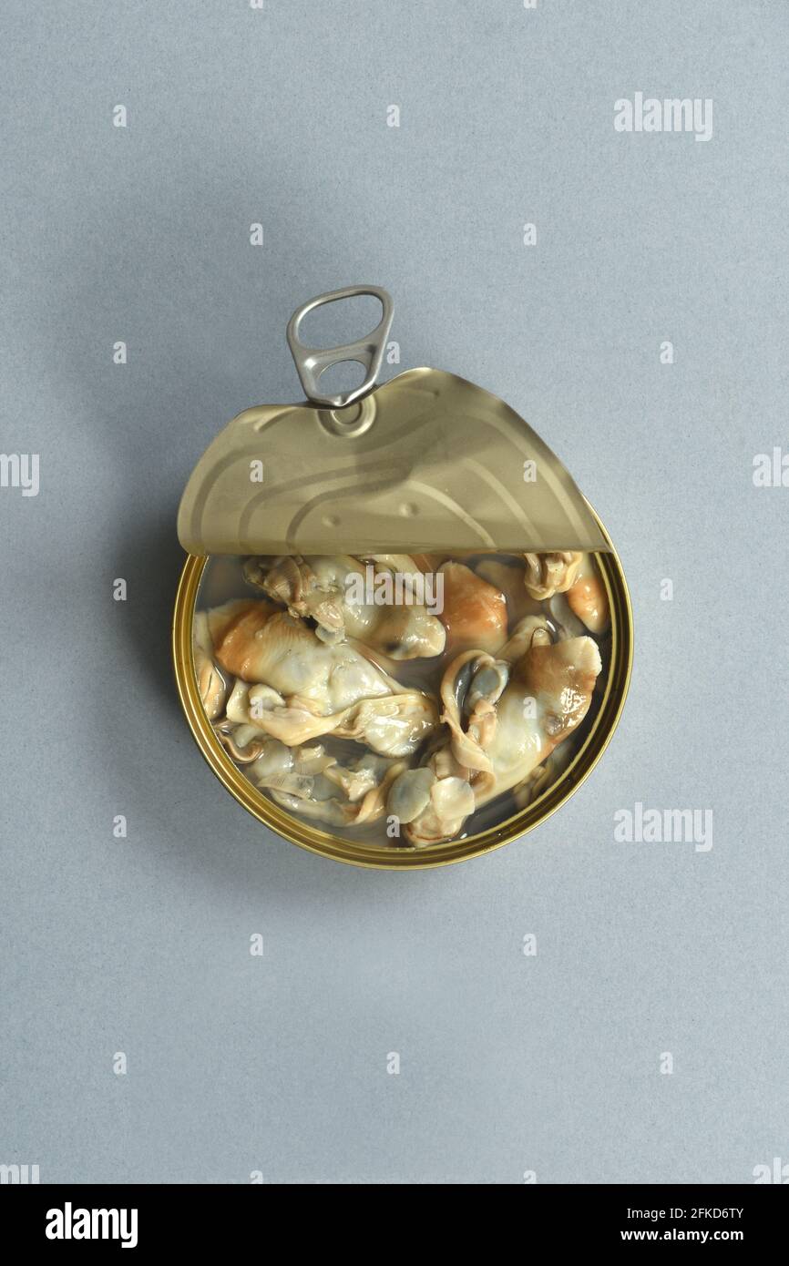 can of razor shells on grey background Stock Photo - Alamy
