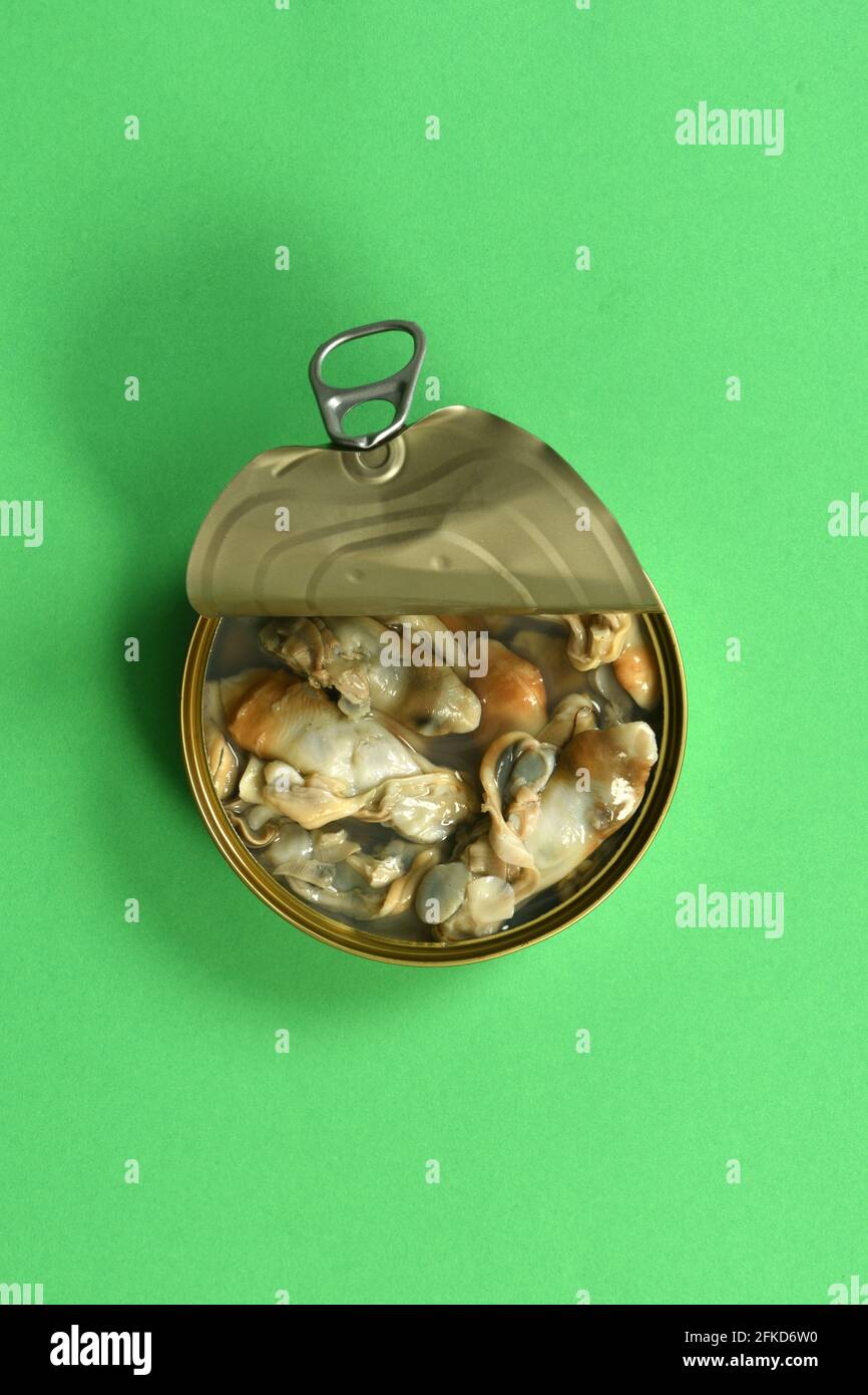 can of razor shells on green background Stock Photo - Alamy