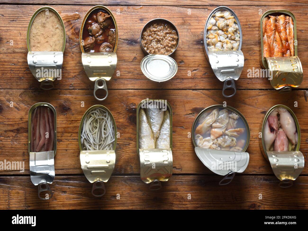 set of cans with fish and seafood on wooden background Stock Photo - Alamy