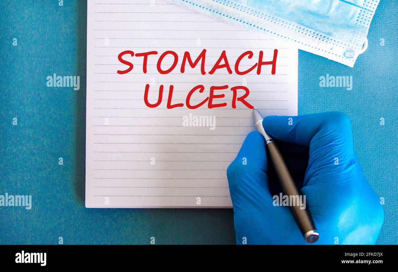 Medical and stomach ulcer symbol. Doctor hand, metalic pen. White note ...