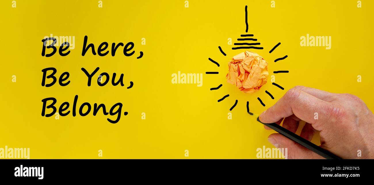 Belonging symbol. Businessman writing words 'be here, be you, belong ...