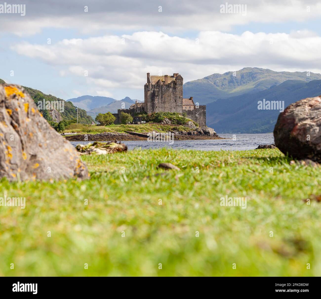 A castle on top of a grass covered field with Eilean Donan in the ...