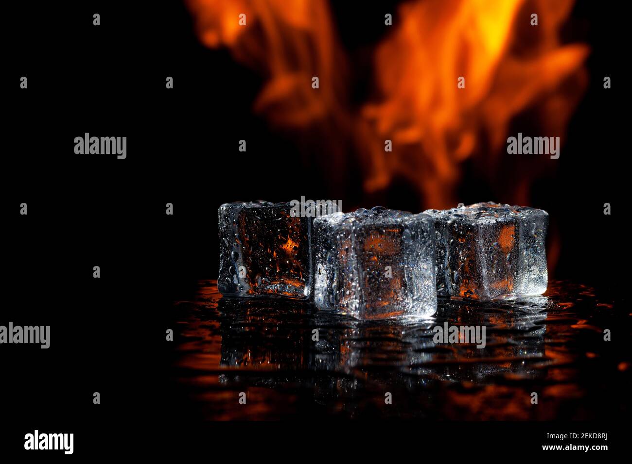 three ice cubes against the background of fire, concept Stock Photo - Alamy