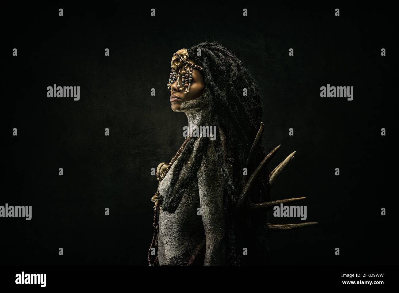 Portrait of a shaman covered in clay, wearing dreadlocks and bone ...