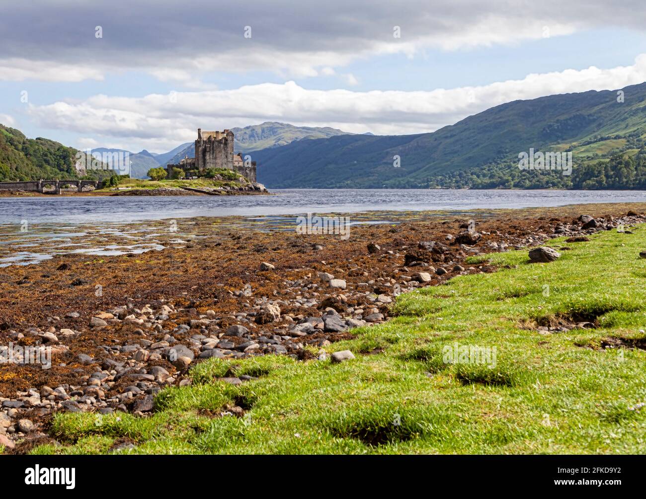 A castle on top of a grass covered field with Eilean Donan in the ...