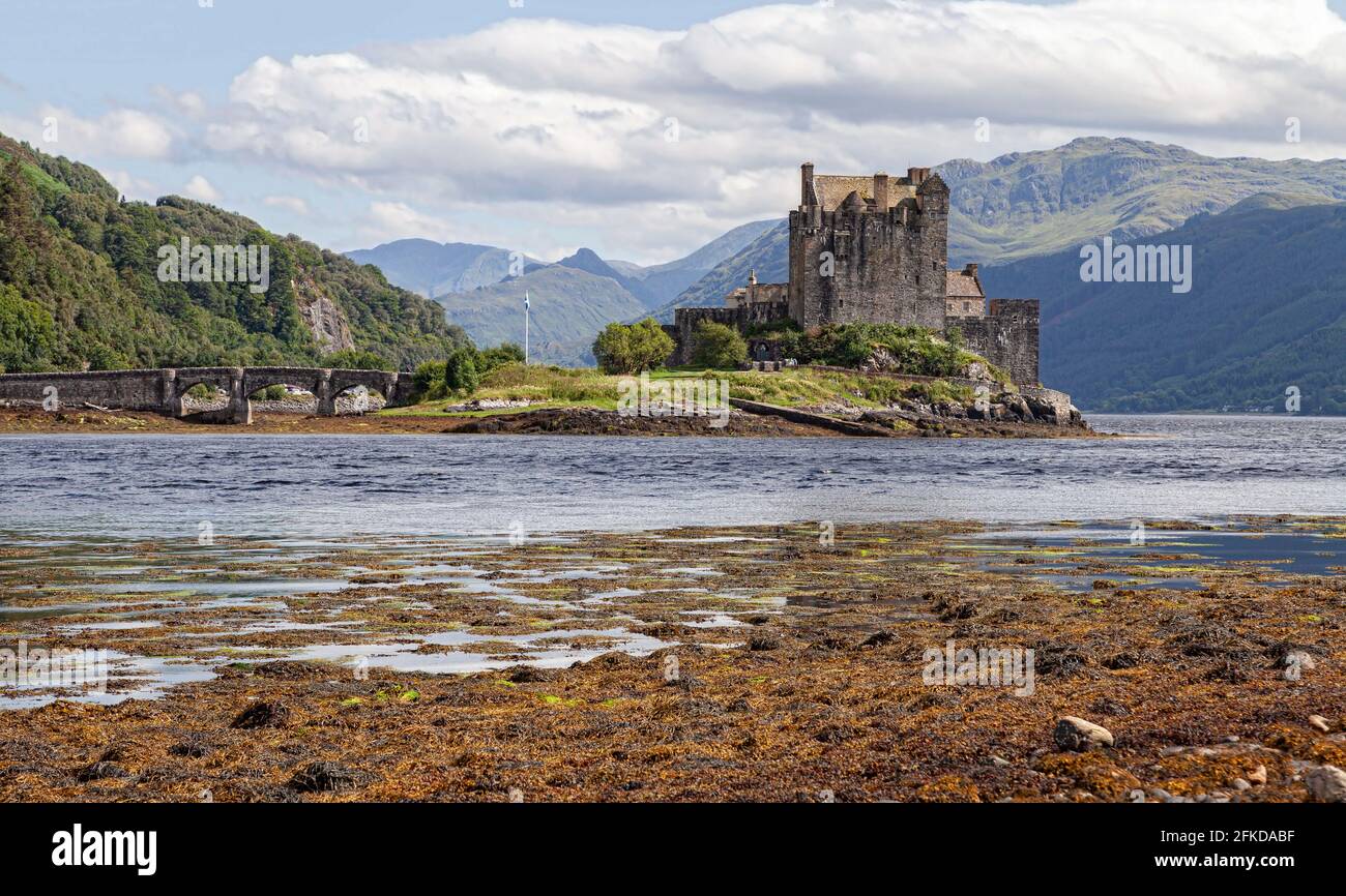 A castle on top of a grass covered field with Eilean Donan in the ...