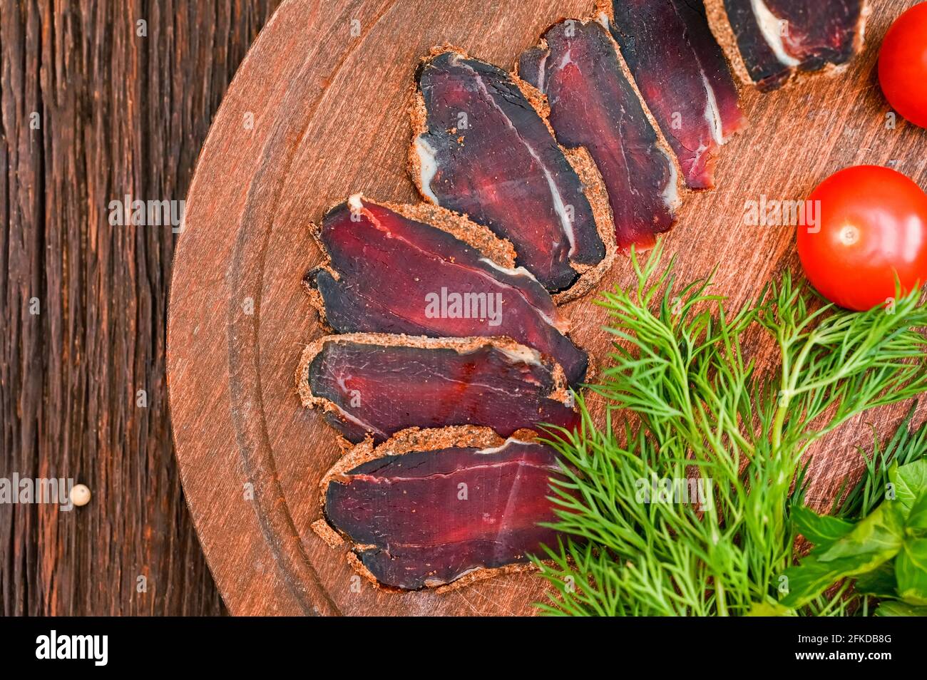 Close-up top view of sliced assorted dry-cured meat on the wooden gray ...