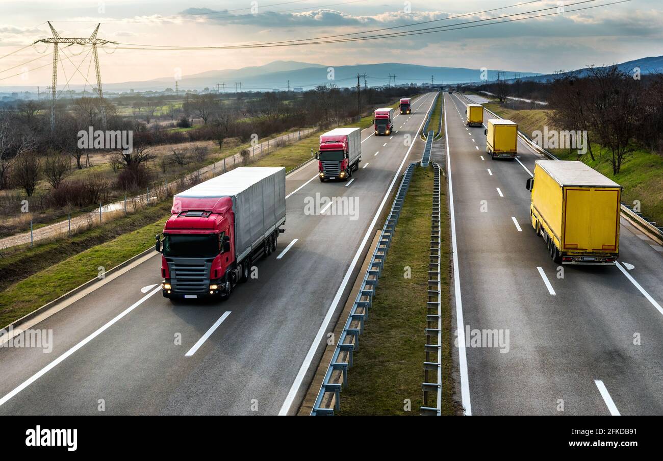 Convoys or caravans of transportation trucks passing on a highway at ...