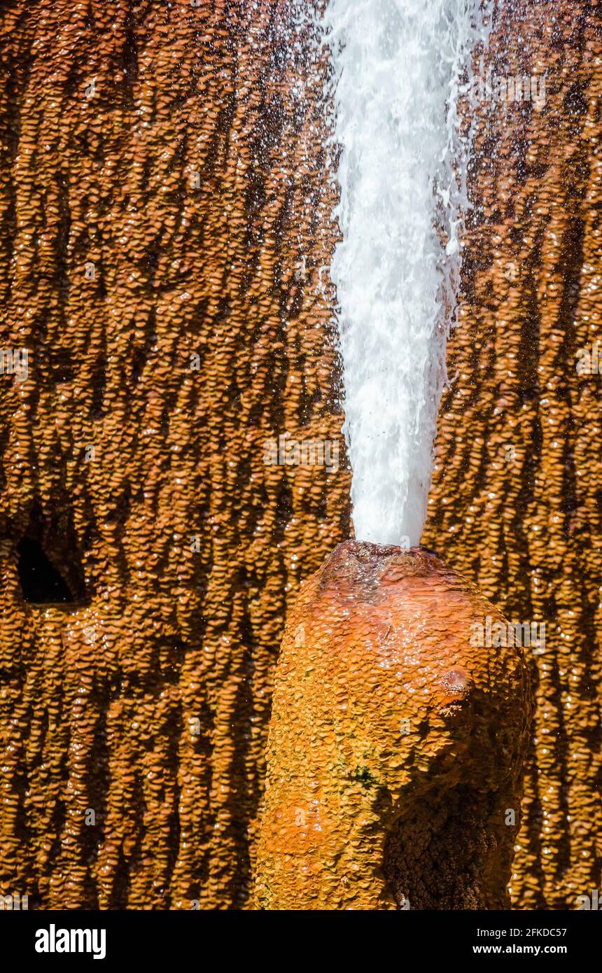 Phallic shape tube with strong stream splashing water to the air in ...