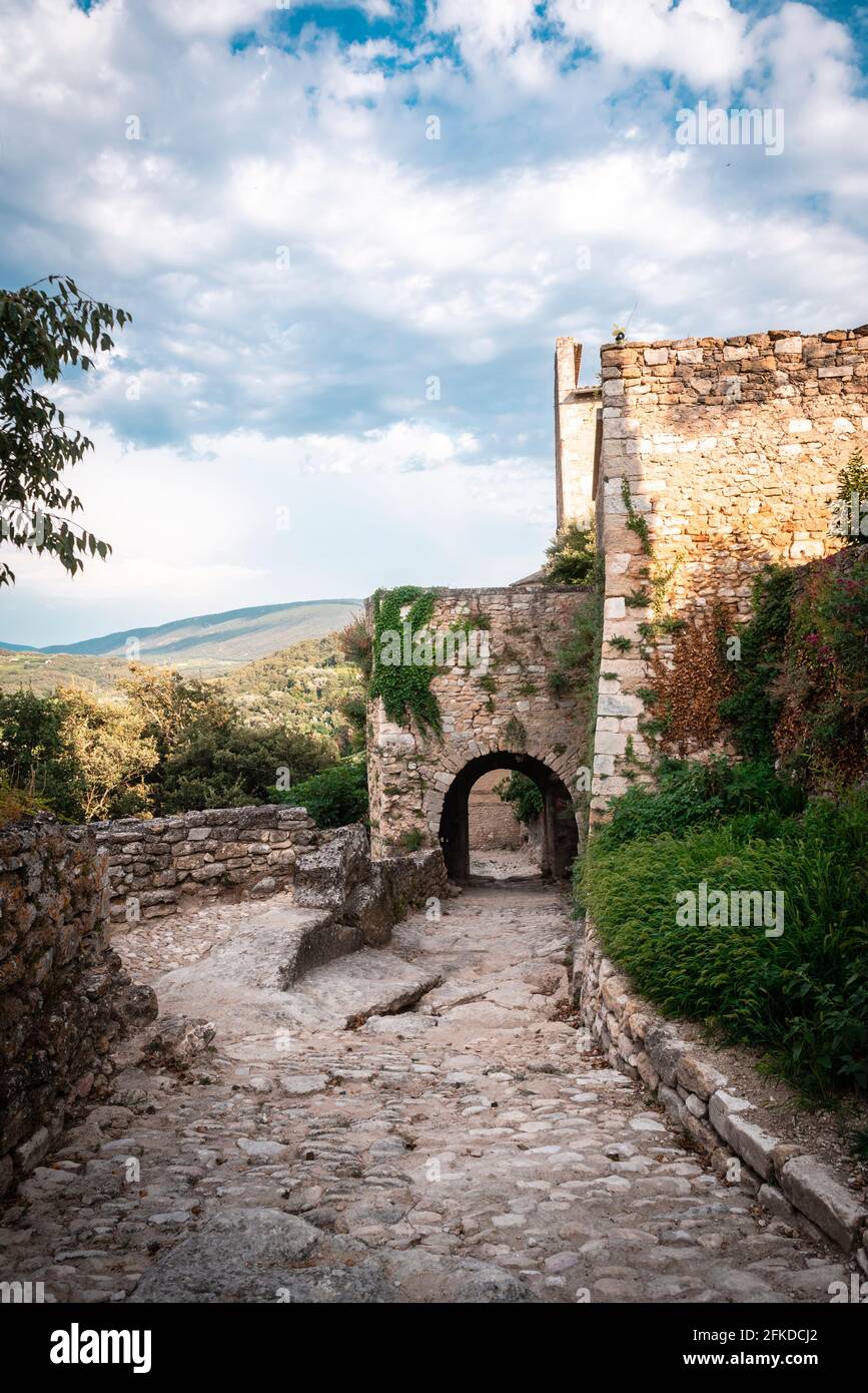 Cobbled street and building with an arch Stock Photo - Alamy