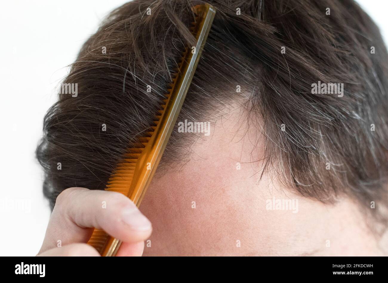 Man combing his hair Stock Photo - Alamy